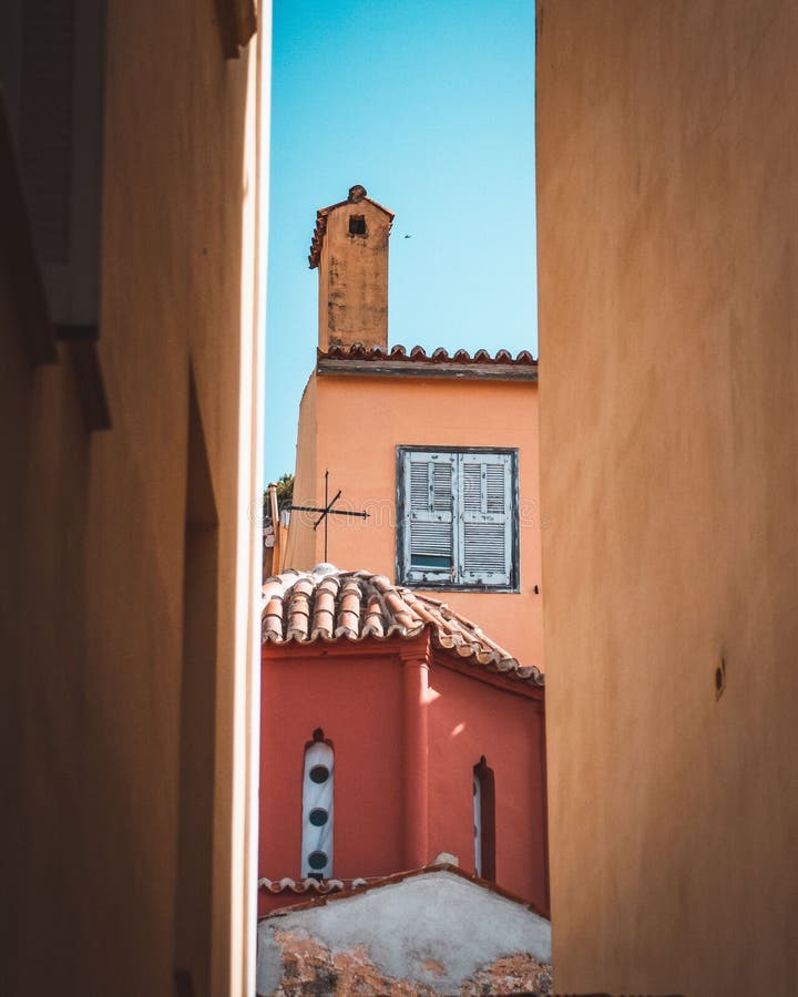 Low-angle of a Sunlit Building through High Walls Against Clear Sky ...