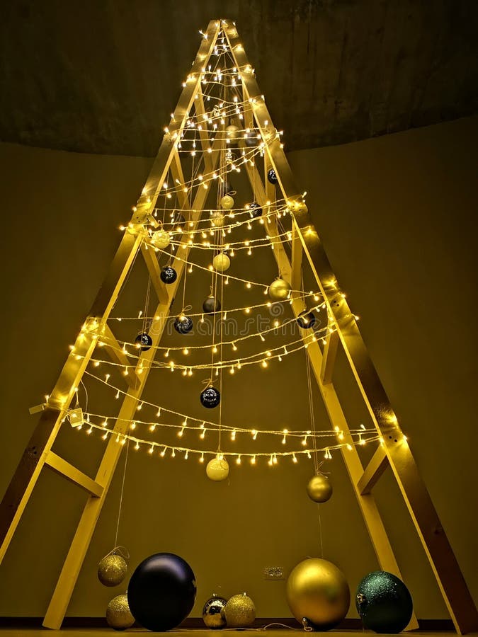Low Angle Vertical Shot of a Ladder Decorated with Christmas Lights and ...