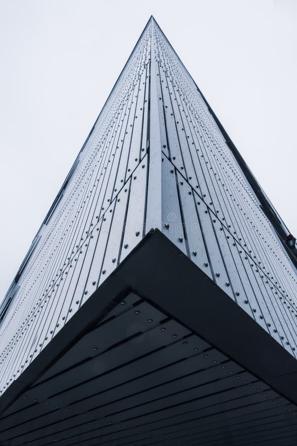 Low Angle Vertical Shot of a Tall Building with a Gloomy Sky in the ...
