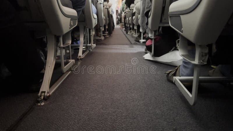 View of Aisle Pathway on Airplane with Passengers on Seats ...