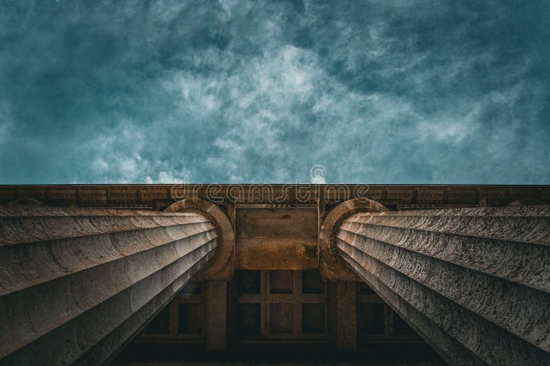 Low Angle View of Ancient Stone Columns with a Dramatic Cloudy Sky ...