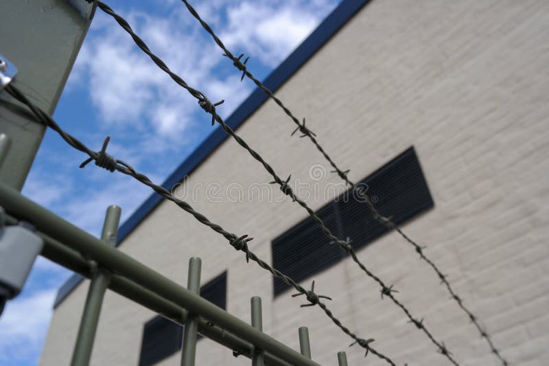 Low Angle View of Barbed Wire in Front of Building Stock Photo - Image ...