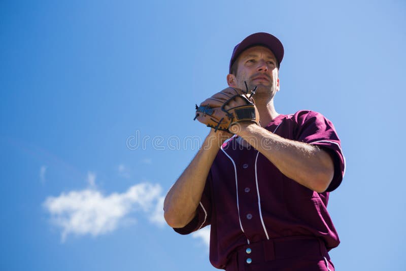 Low Angle View of Baseball Pitcher Standing Against Blue Sky Stock ...