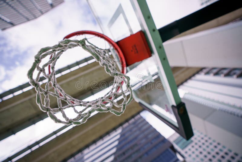 Low Angle View of a Basketball Net Under Railroad in the City Stock ...