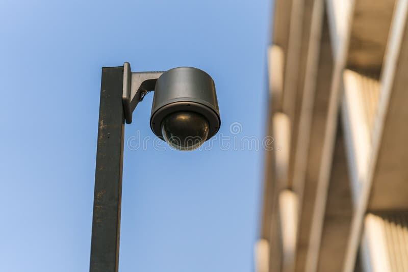Low-angle View of a Black Security Camera Column by a Residential ...