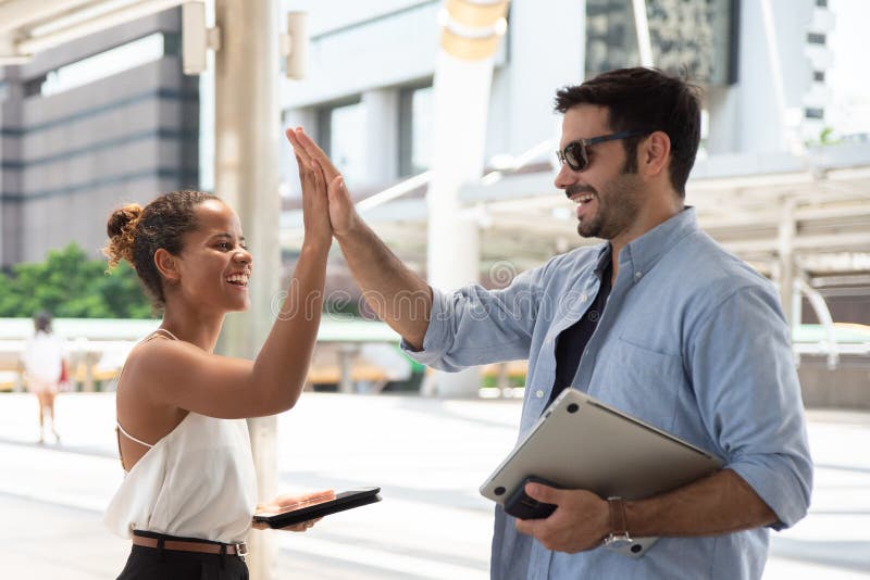Low Angle View of Business People Giving High Five in City Stock Photo ...
