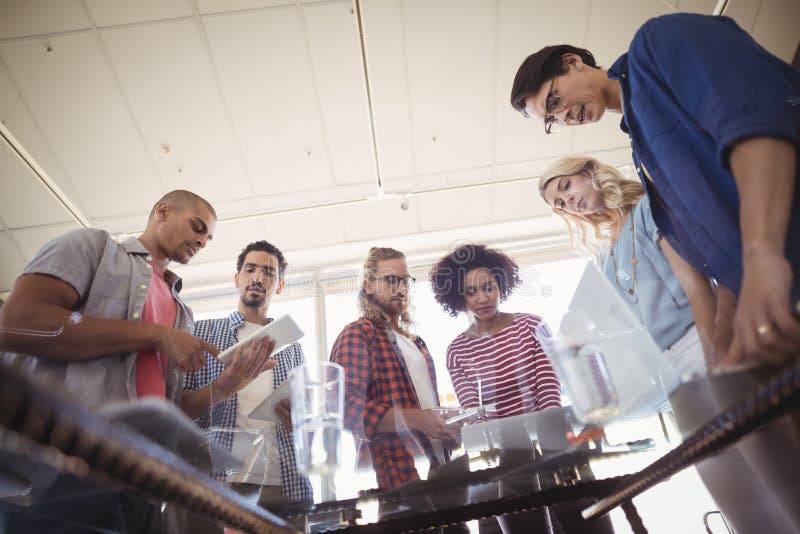 Low Angle View of Business Team Working Together at Desk Stock Photo ...