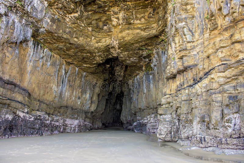 Low Angle View of a Cave with High Rocky Walls Surrounded by Water ...