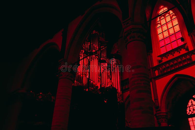 Low Angle View of a Church with Arcs and Columns Under a Red Neon Light ...