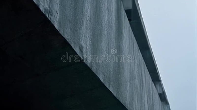 Looking Up at Underside of Concrete Structure Against Overcast Sky ...