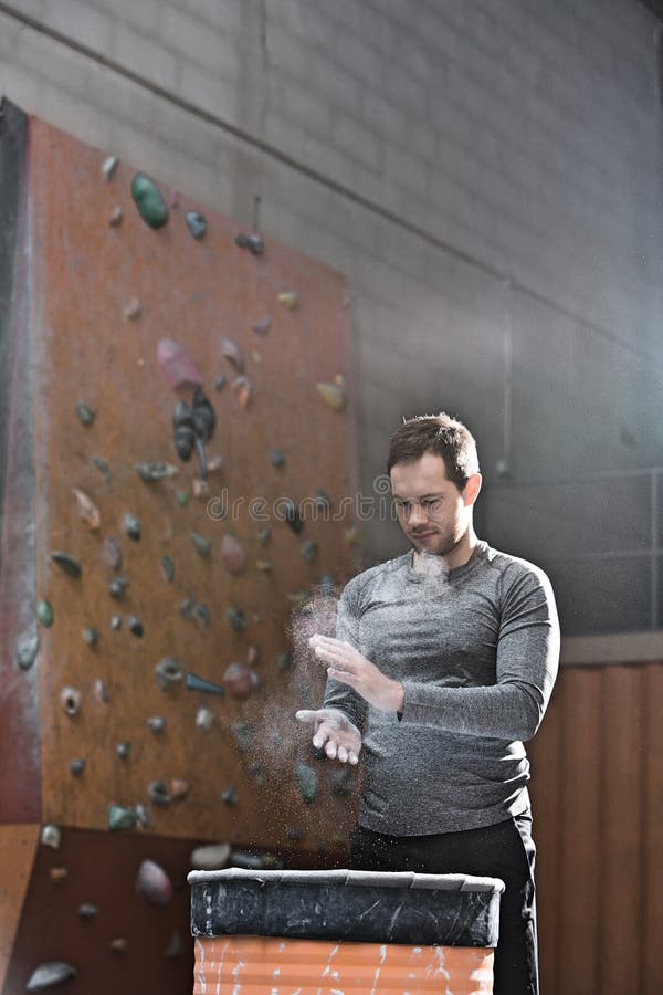 Low Angle View of Confident Man Dusting Powder by Climbing Wall in ...