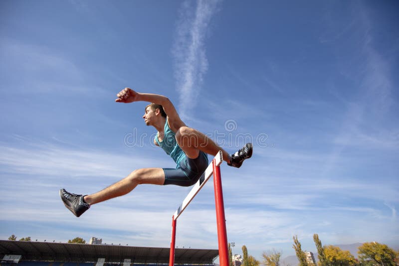 Low Angle View of Determined Male Athlete Jumping Over a Hurdles Stock ...