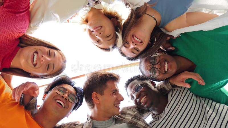 Low Angle View of a Diverse Group of Young People Forming a Circle ...