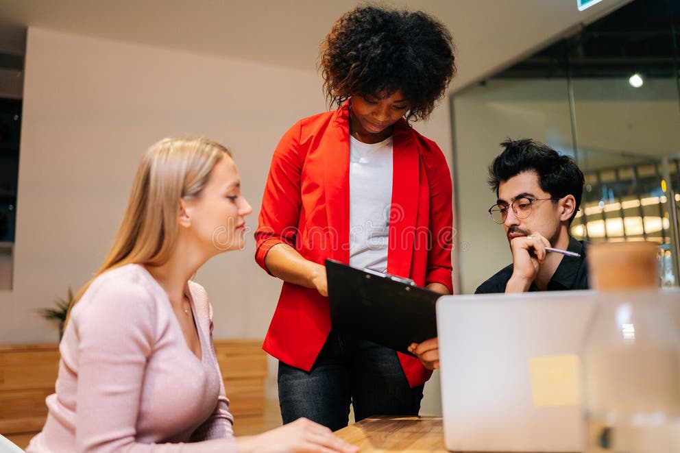Low-angle View of Doubtful Young Businessman Reading Contract Document ...