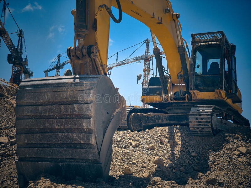 Excavator Scoop Moving a Rock Boulders during Road Construction on the ...