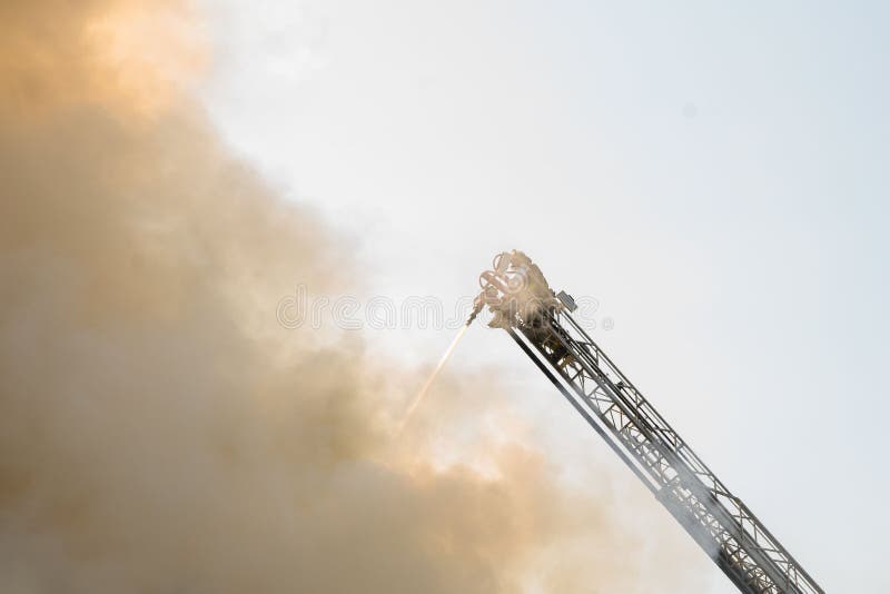Low Angle View of Firefighter Extinguishing a Fire Stock Photo - Image ...