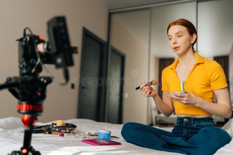 Low-angle View of Ginger Female Makeup Blogger Applying Blusher on Face ...