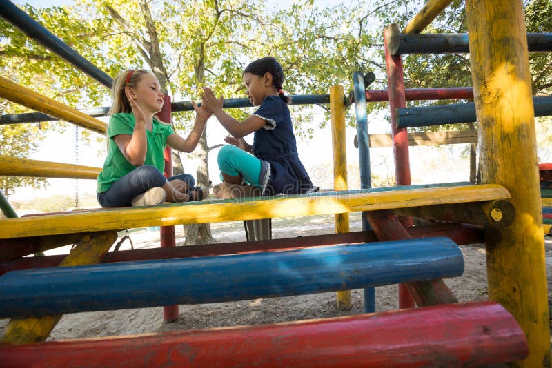 Low Angle View of Girls Playing Clapping Game on Jungle Gym Stock Image ...