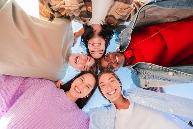 Low Angle View of a Group of Multiracial Young Friends Hugging in a ...