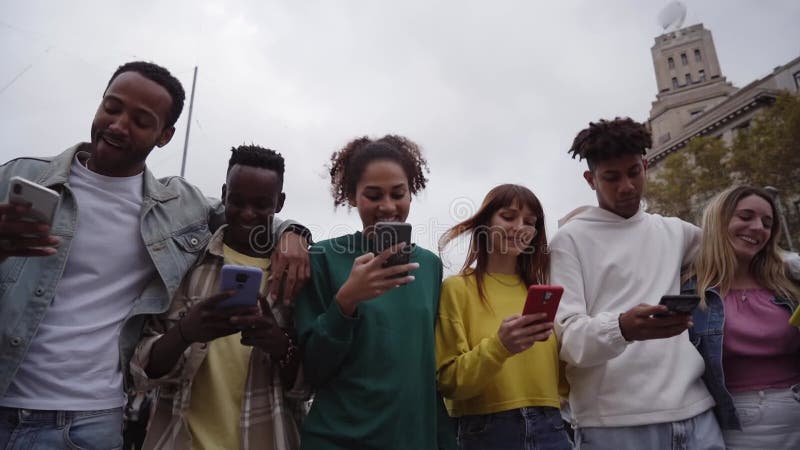 Low Angle View of a Group of Young Teenagers Using Cell Phones. Concept ...