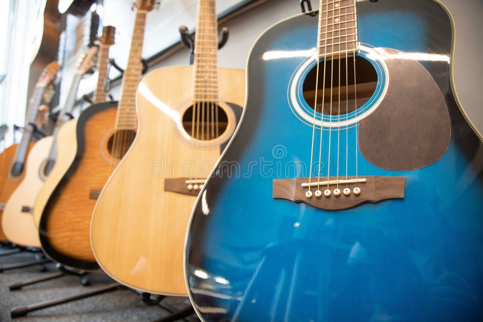 Low Angle View of Guitars on Sale. Stack of Musical Instruments Stock ...