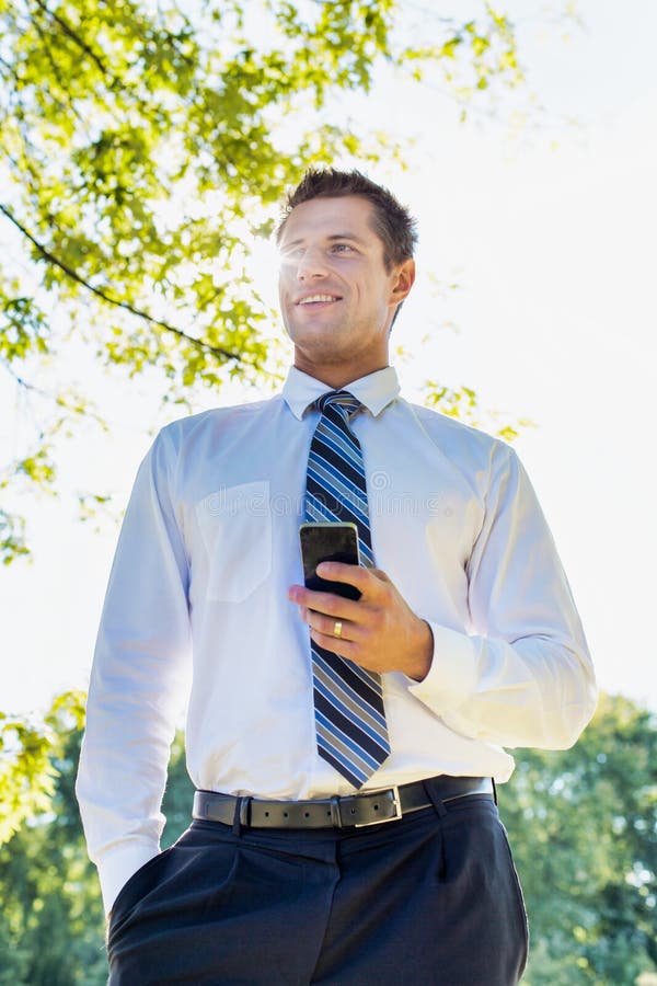 Low Angle View of Handsome Mature Businessman Using Smartphone Stock ...