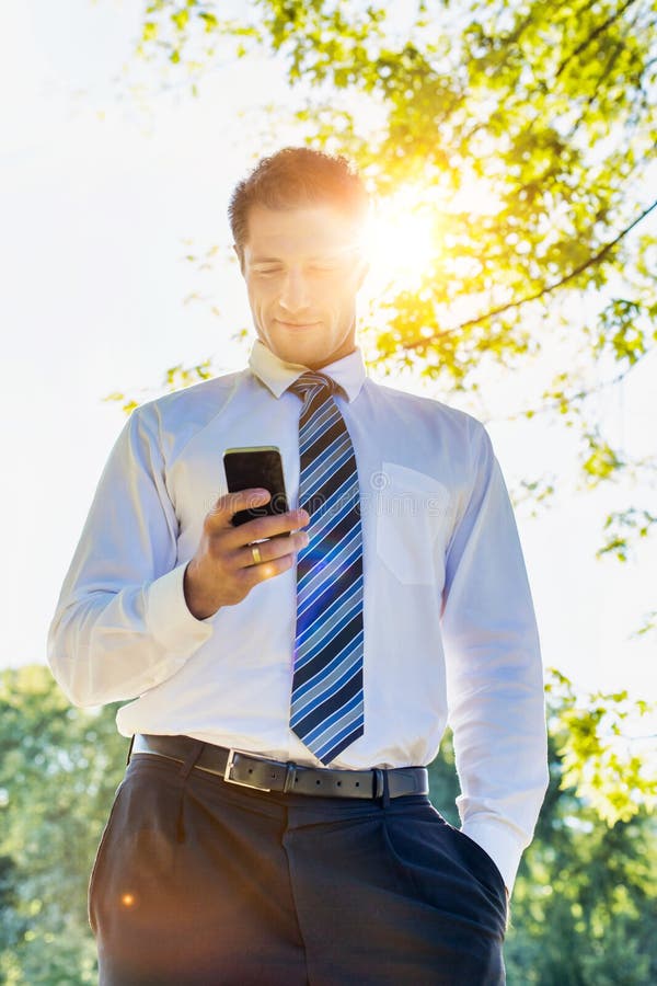 Low Angle View of Handsome Mature Businessman Using Smartphone Stock ...