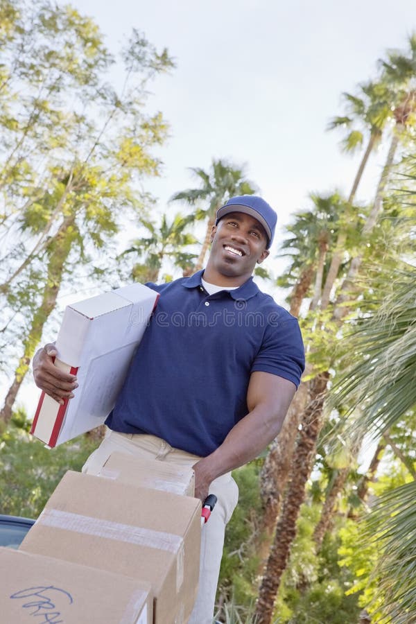 Low Angle View of a Happy Delivery Male with Packages Stock Image ...