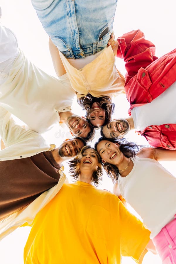 Low Angle View of Happy Group of Young People in Circle Smile at Camera ...
