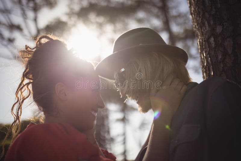 Low Angle View of Happy Young Couple Standing Face To Face Stock Photo ...