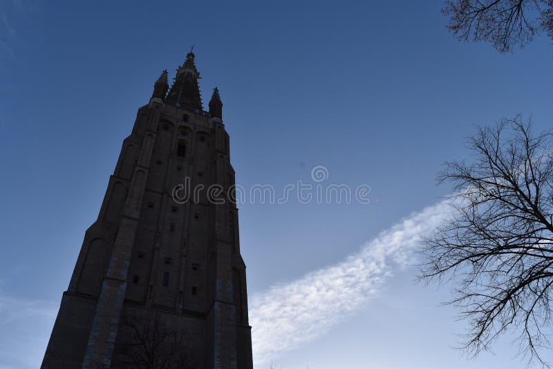 Low-angle View of a Large Medieval Gothic-style Tower in Backlight ...