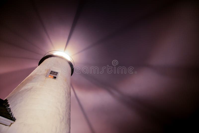 Low-angle View of a Lighthouse Tower Illuminating the Night Sky Stock ...