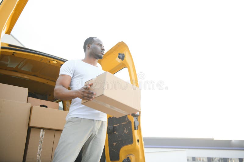 Low Angle View of Loader Man Standing Near the Van Holding Cardboard ...