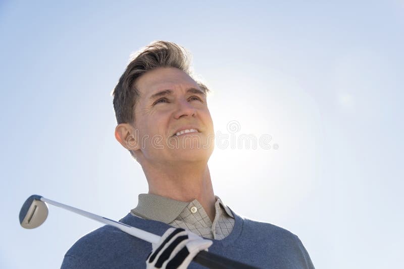 Low Angle View of Man Holding Golf Club Against Sky Stock Image - Image ...