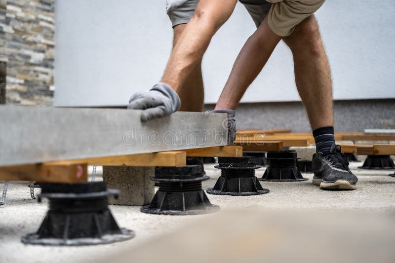 Low Angle View of a Man Leveling a Supportive Construction for Wooden ...