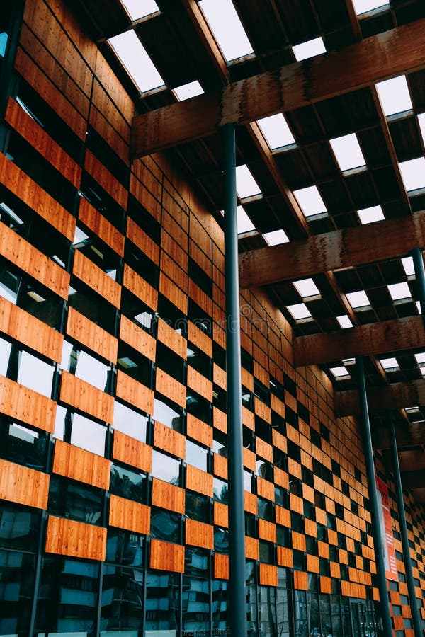 Low Angle View of a Modern Building with Wooden Walls and Blue Windows ...