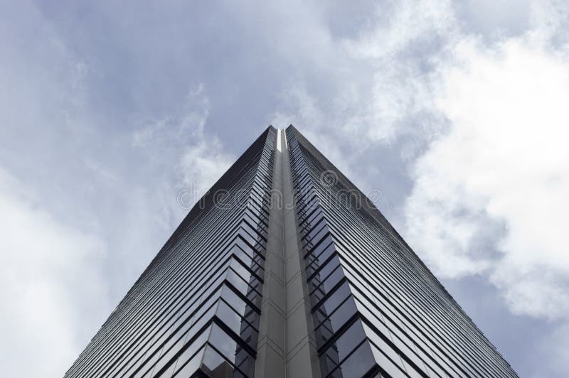 Low Angle View of a Modern Skyscraper Corner with Cloudy Sky at ...