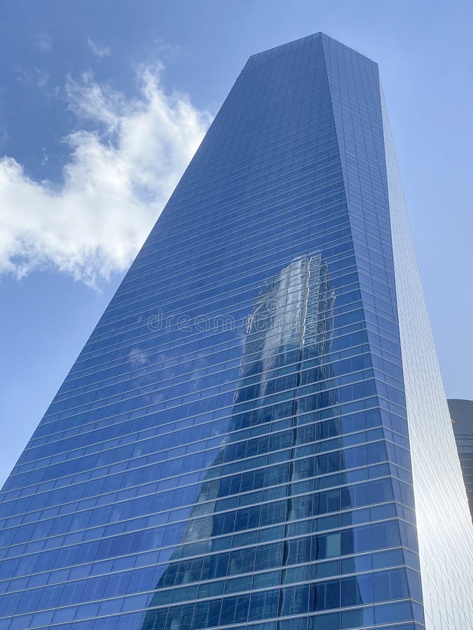 Low Angle View of Modern Skyscraper. Second Building is Reflected in ...