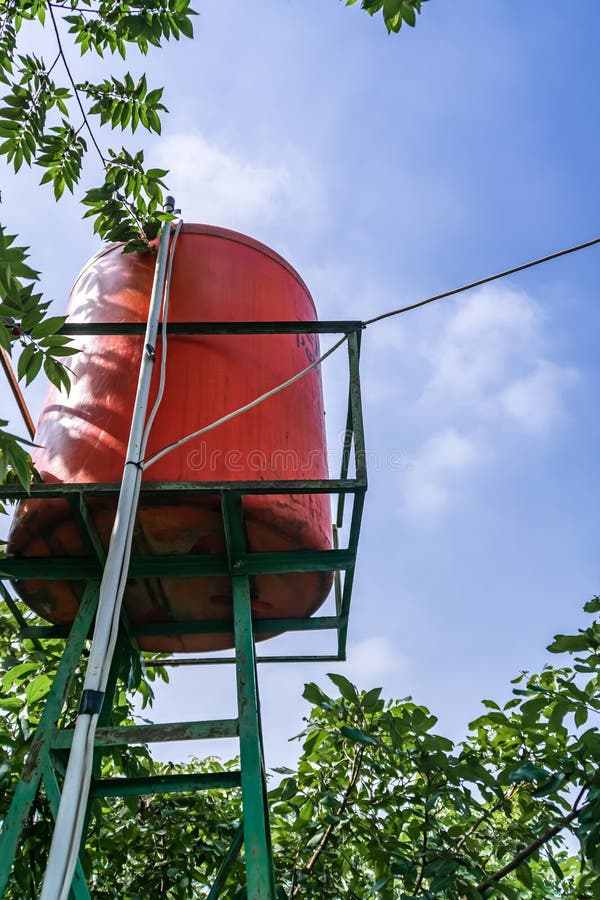 Low Angle View of Orange Water Big Tank Under the Blue Morning Sky ...