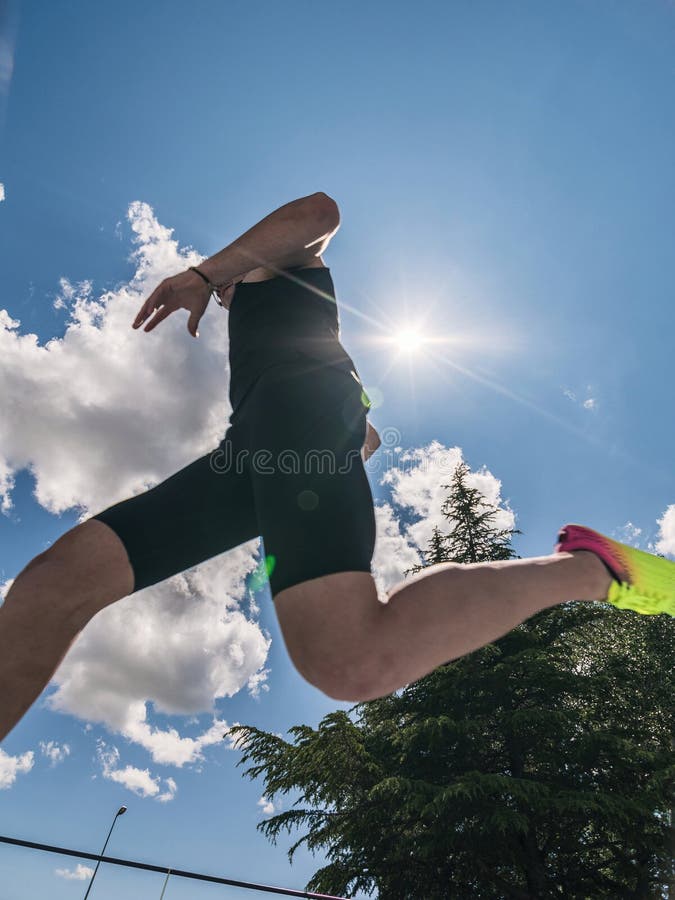 Low Angle View of a Person Running in the Air with the Sun Shining on ...