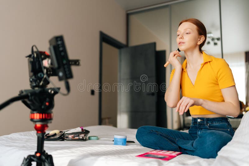 Low-angle View of Redhaired Female Beauty Blogger Making Video Tutorial ...