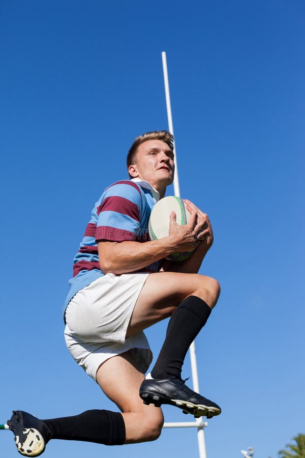 Low Angle View of Rugby Player Catching Ball Stock Photo - Image of ...