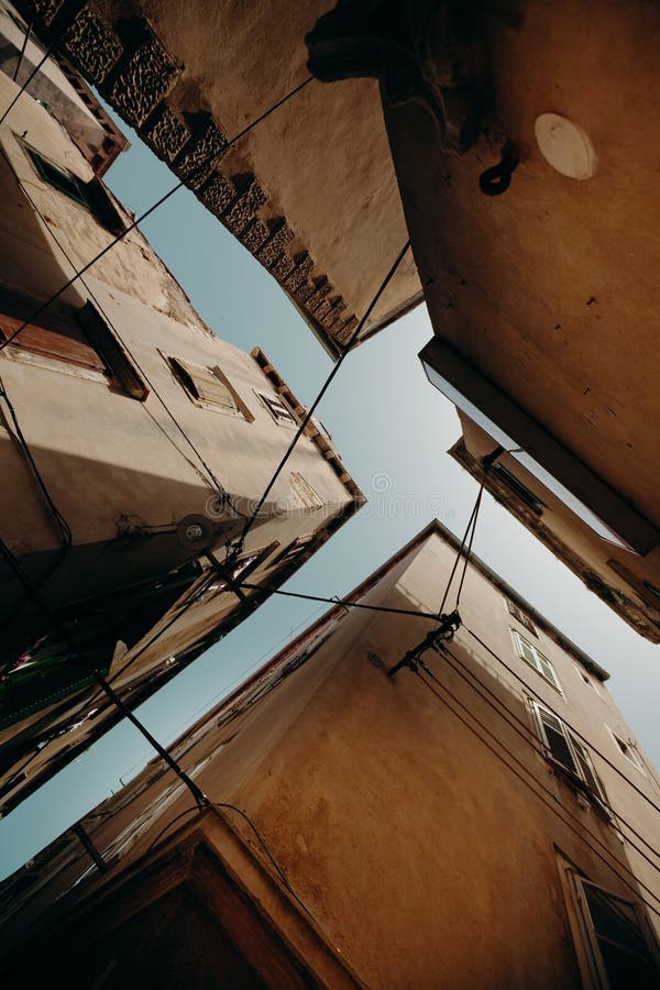 Low-angle View of Rustic Buildings with Intersecting Wires Against a ...