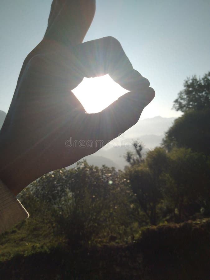 Low Angle View of Silhouette Hand Holding Sun during Sunset Stock Photo ...