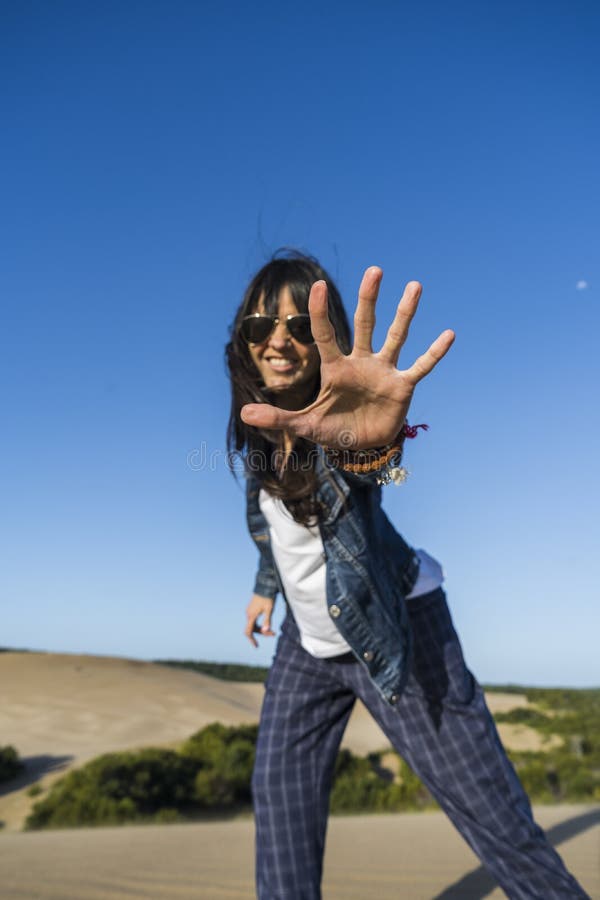 Low Angle View of a Similing Woman Showing the Palm of Her Hand in a ... Low Angle View of a Similing Woman Showing the Palm of Her Hand in a ...