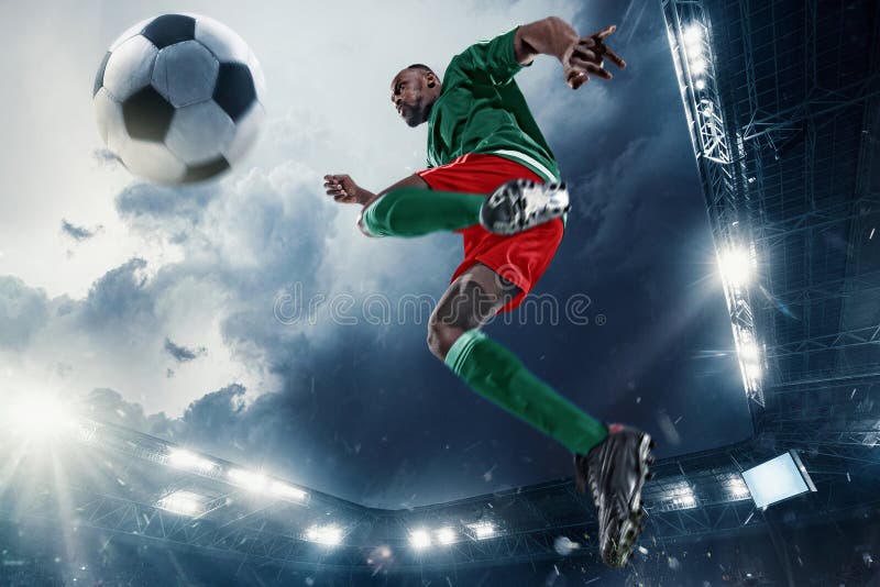 Low Angle View on Soccer Player in Dynamic Motion, Kicking Ball with ...