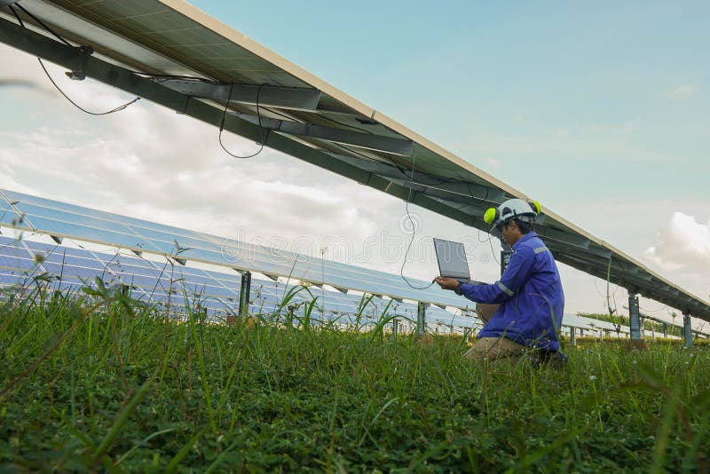 The Low Angle View of the Solar Farm and the Engineers are Using the ...