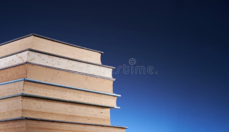 Low Angle View Stack of Books Against Blue Background Stock Image ...
