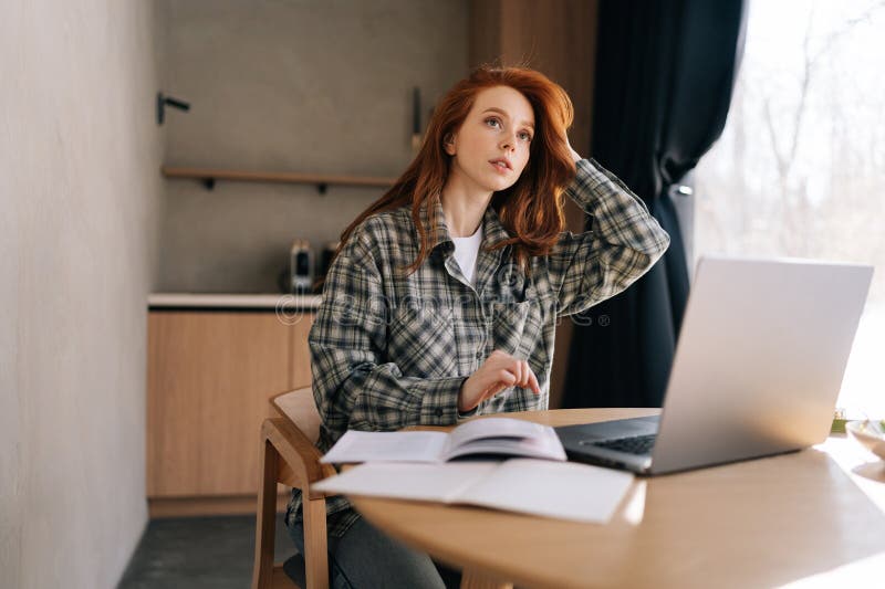 Low-angle View of Thoughtful Female Student Working or Learning Online ...