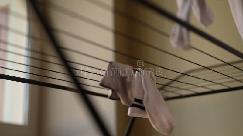 Low-angle View of Unrecognizable Man Hanging Wet White Socks on Metal ...